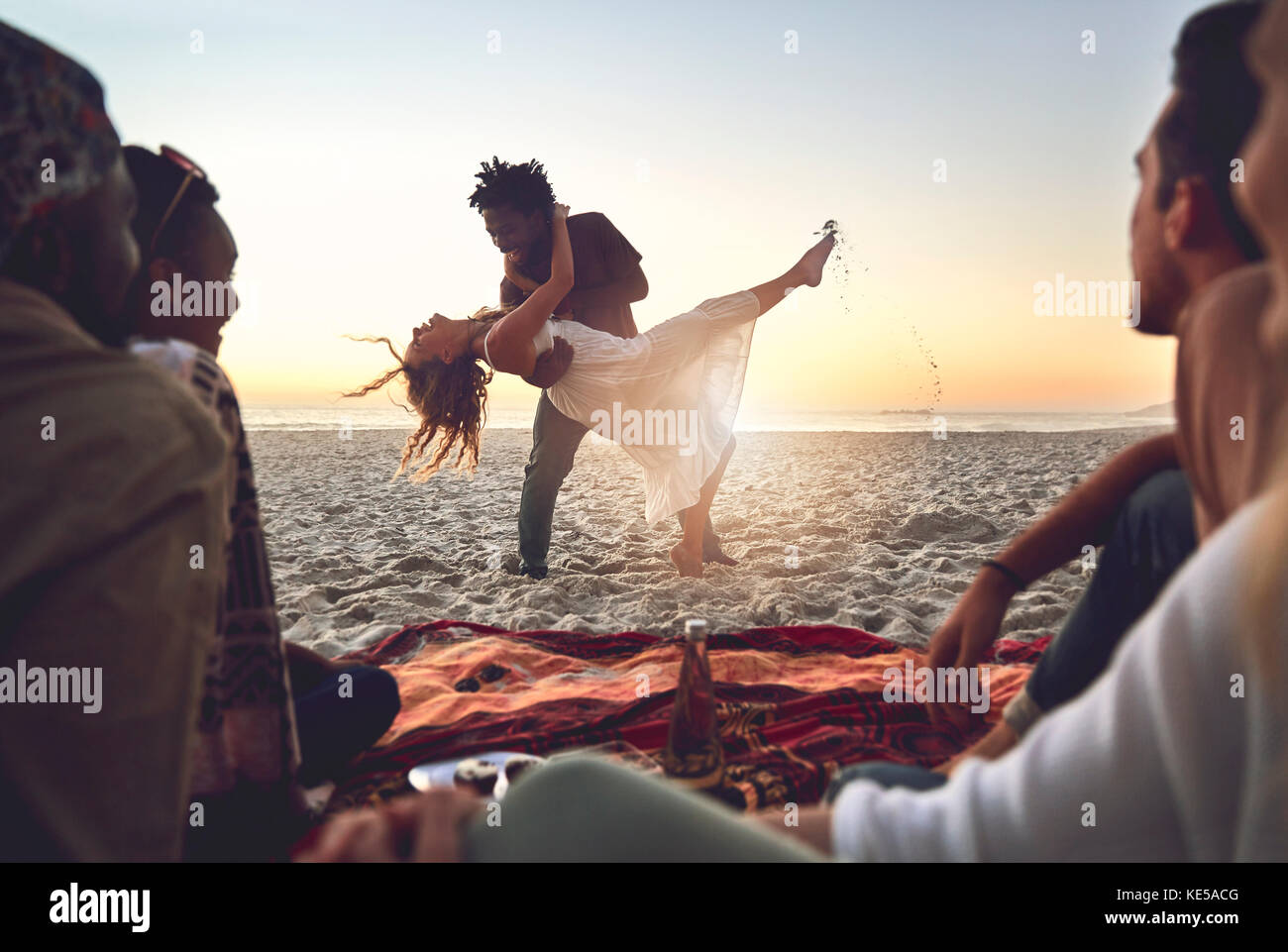 Playful young couple dancing on sunny summer beach Stock Photo - Alamy