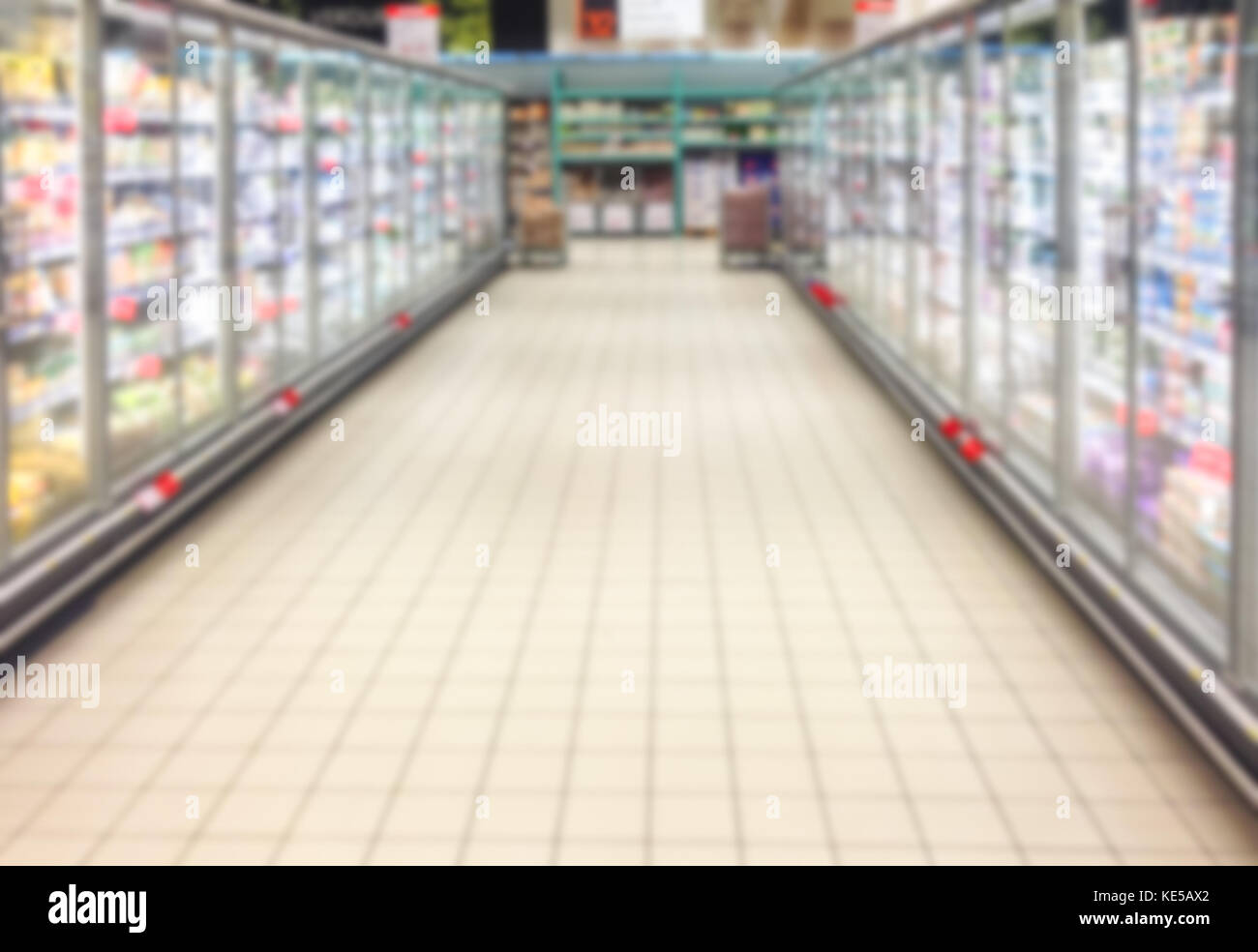 Blurred supermarket background full of products in row Stock Photo - Alamy