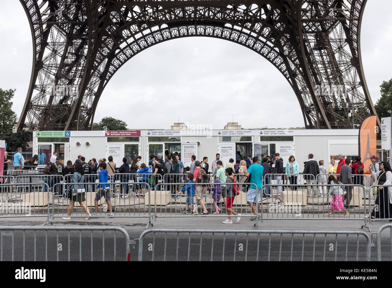 Tourists line up to buy tickets to go up the Eiffel Tower in Paris ...