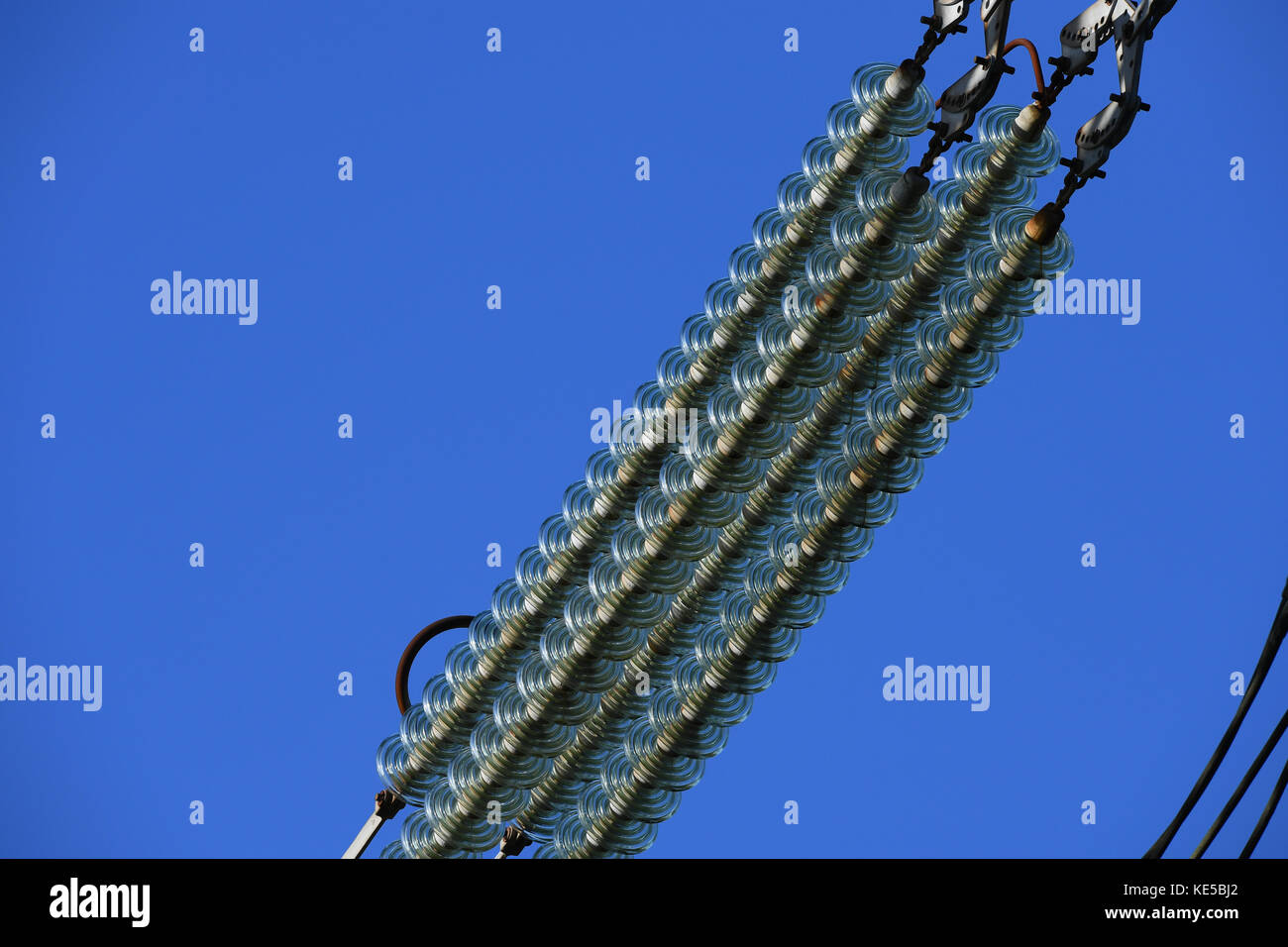 Close up of insulator discs on power lines of a lattice tower Stock ...