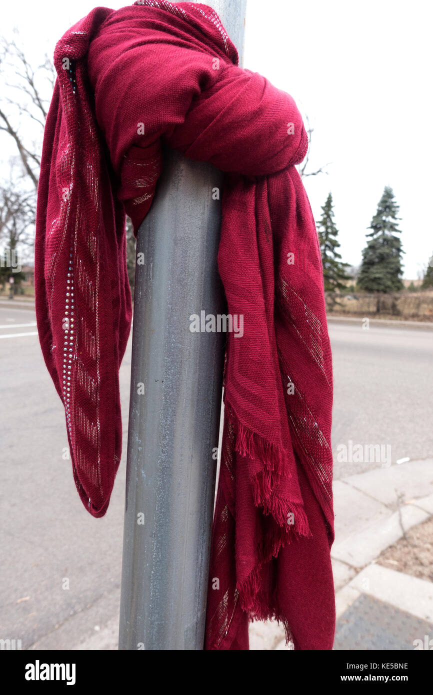 Lost red scarf tied to sign pole hoping that the owner will find it. St ...