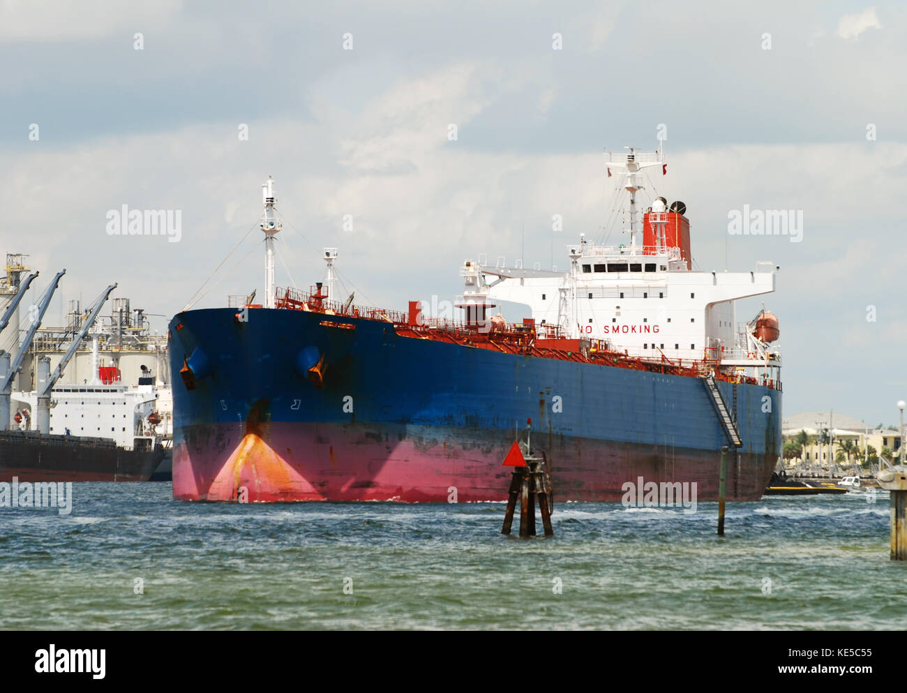 Cargo ship leaving port Stock Photo - Alamy