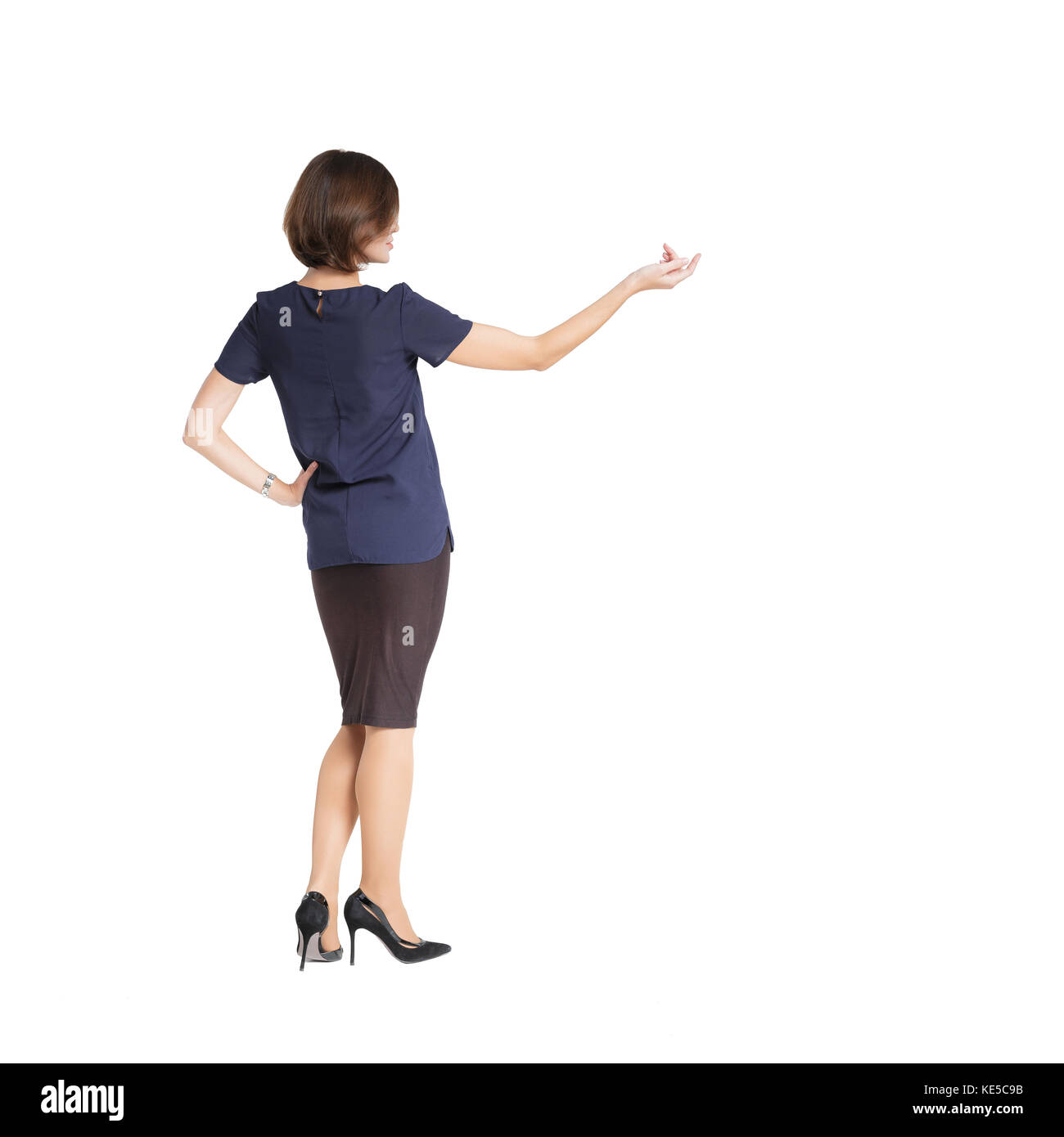 back view of woman showing on something Stock Photo - Alamy