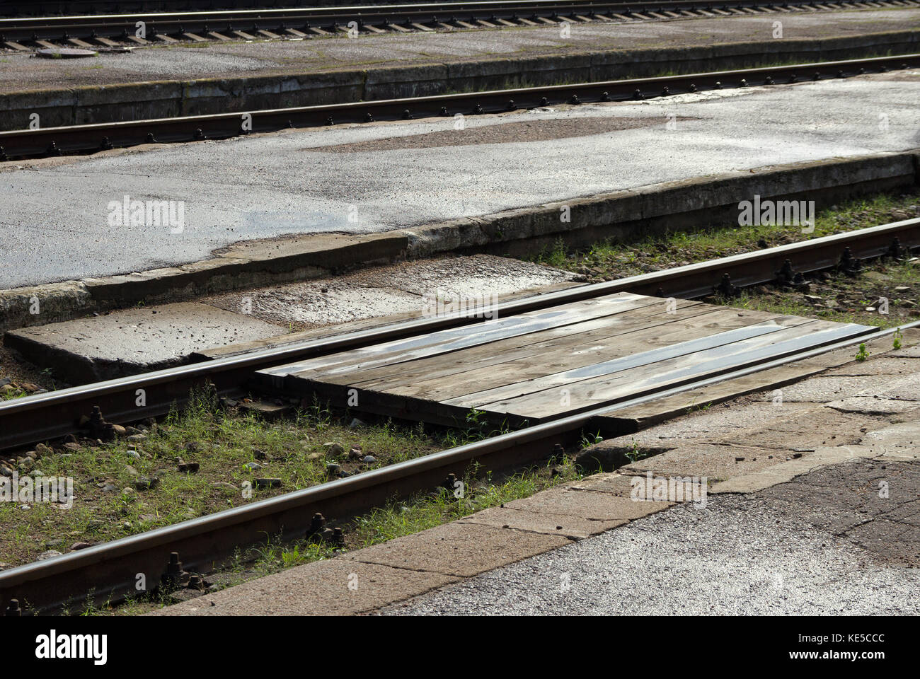 Old wet railway track, crossing over the rails Stock Photo - Alamy