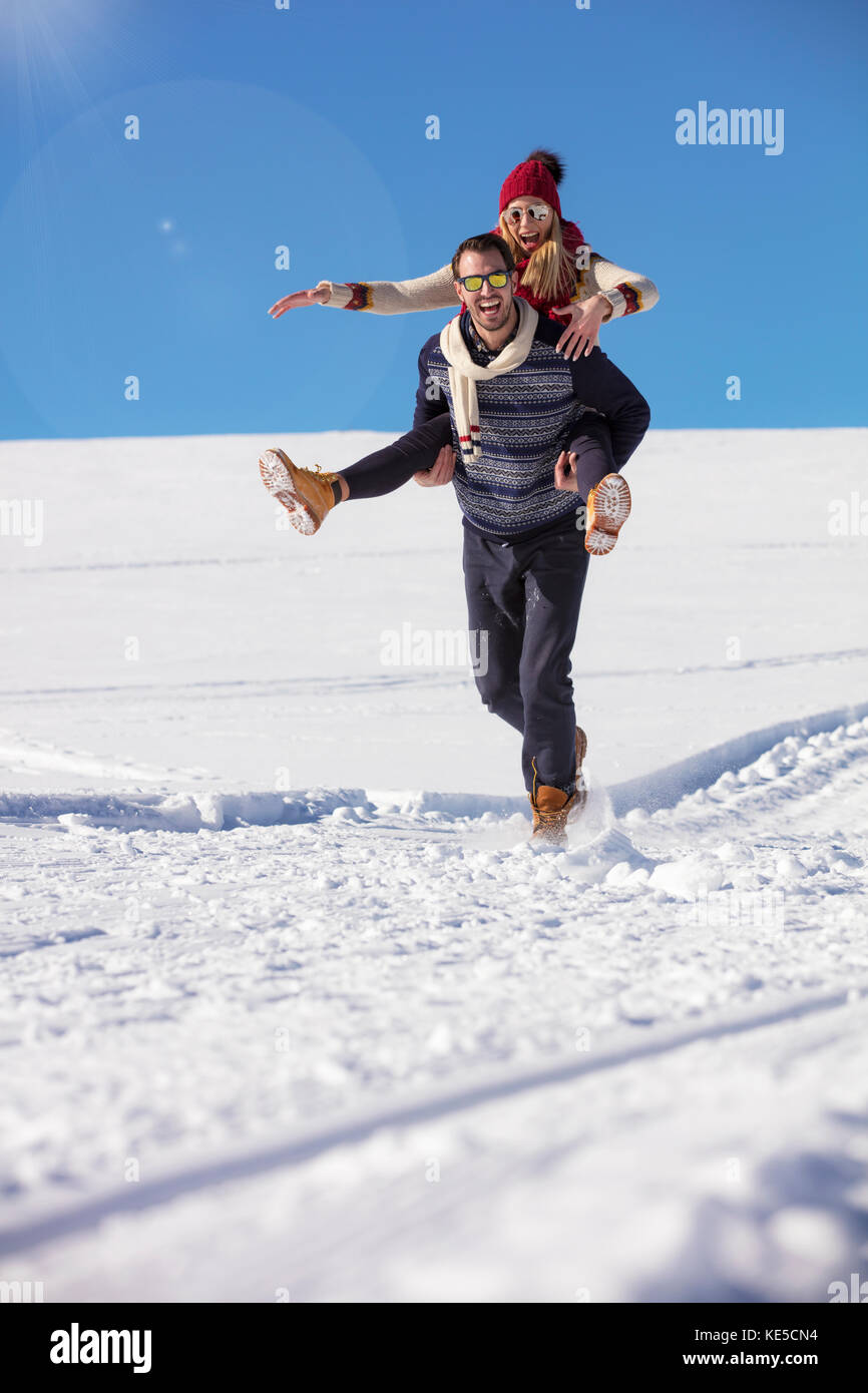 Loving couple playing together in snow outdoor Stock Photo - Alamy
