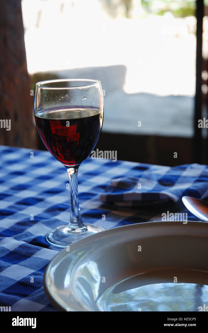 Set table and glass of red wine in a restaurant Stock Photo - Alamy