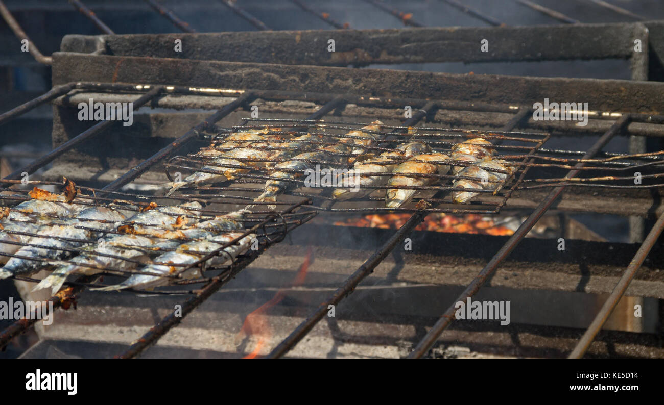 Fried fish on a hot coal on the banks of the river Dora in Portugal ...