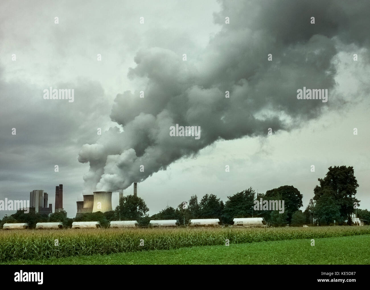 pollution factory chimney smoke green fields agriculture foreground ...