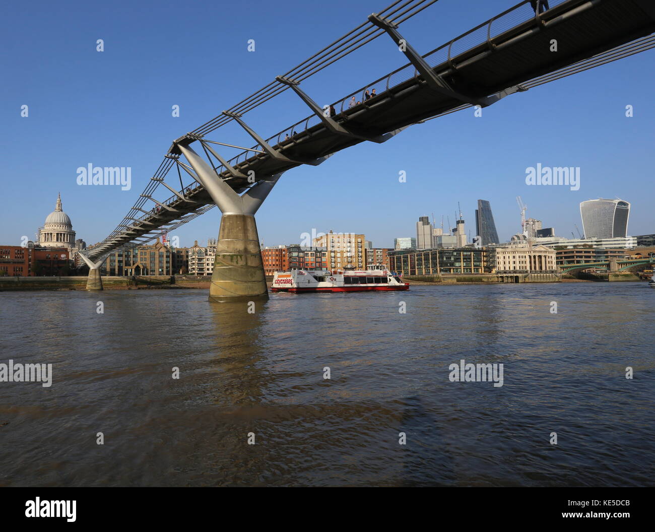 Sightseeing boat passing under Millennium Bridge London UK October 2017 ...