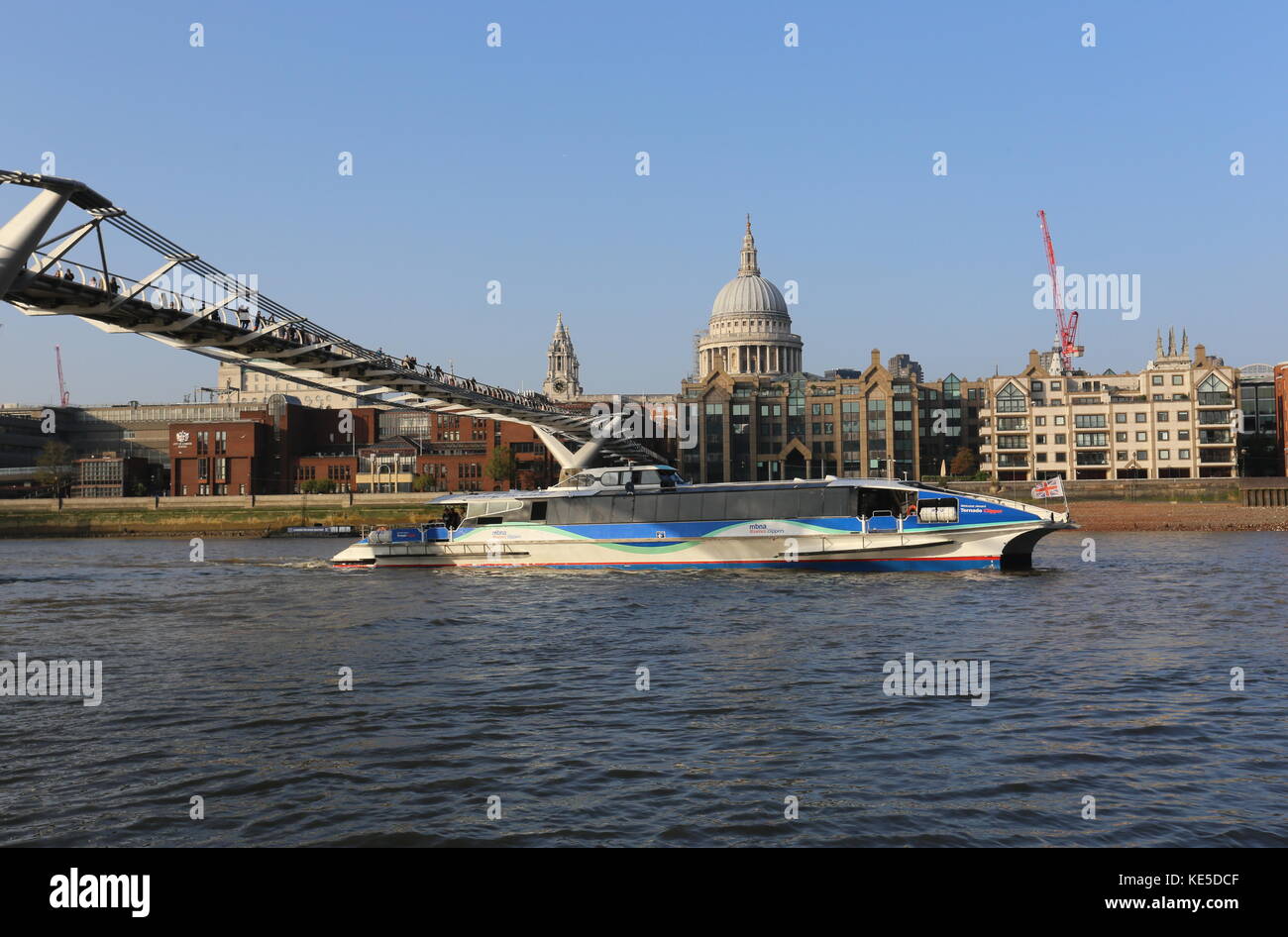 Thames clipper passing under Millennium Bridge London UK October 2017 ...