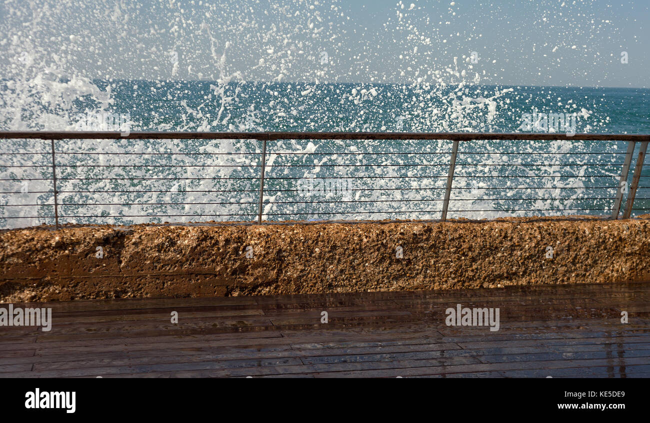 Water splash and slippery promenade at the Mediterranean sea in Tel ...