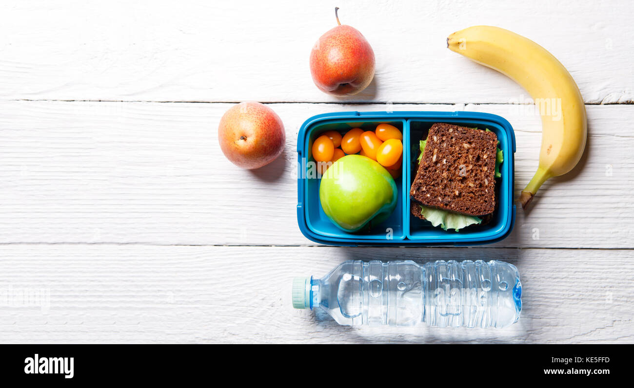 Picture of sporting healthy snack in lunchbox, pear, banana, water ...