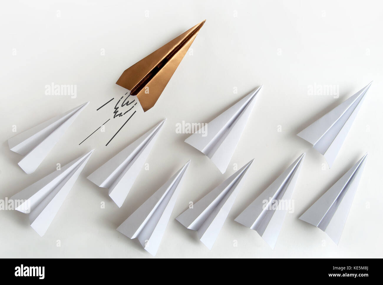 Gold paper plane standing out in a line Stock Photo - Alamy