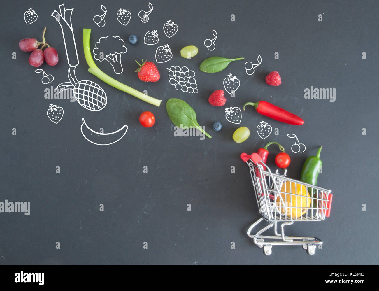 Grocery shopping cart filled with fruits and vegetables and sketches on ...