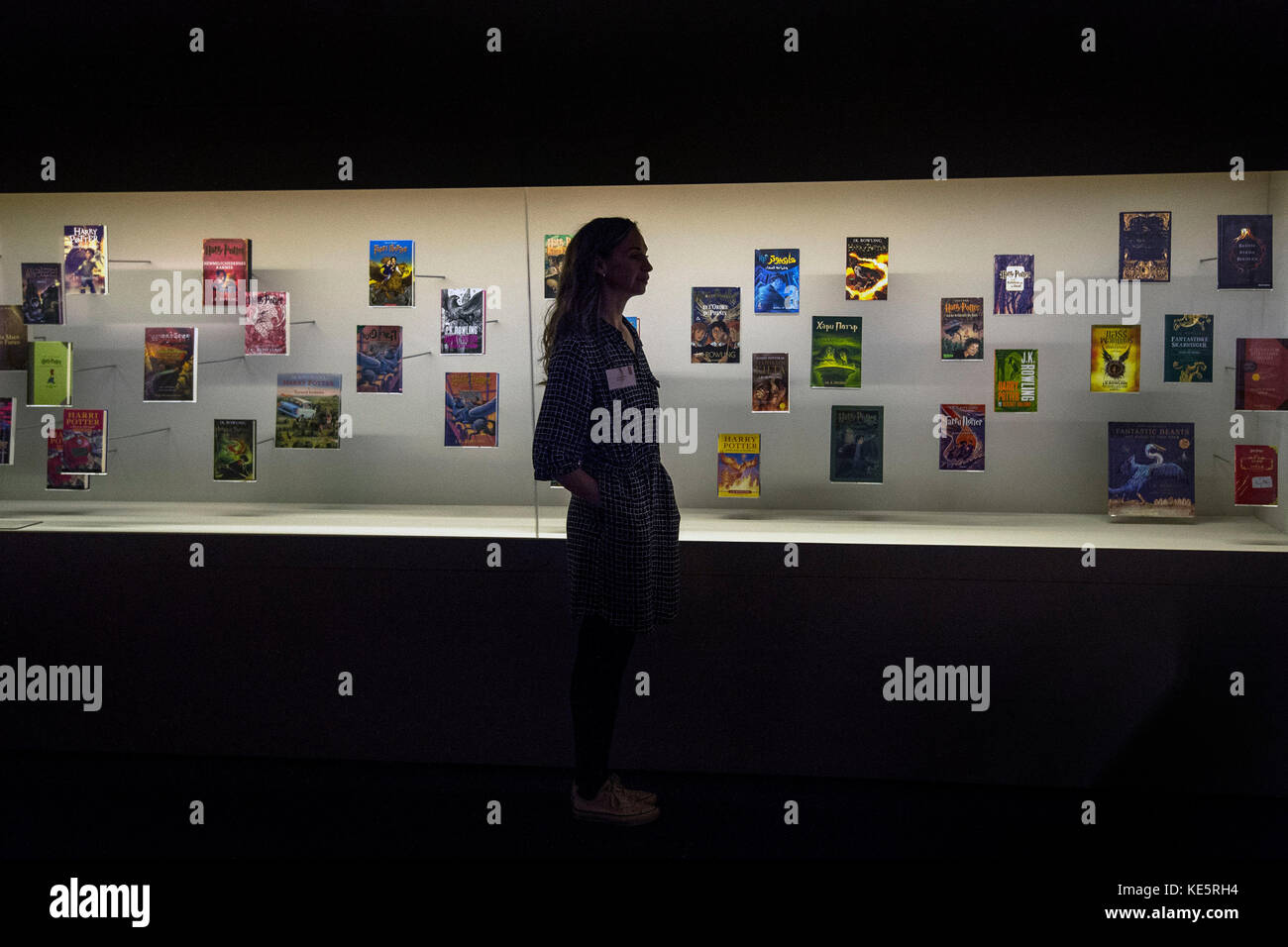 A visitor walks past a display of foreign language editions of the ...