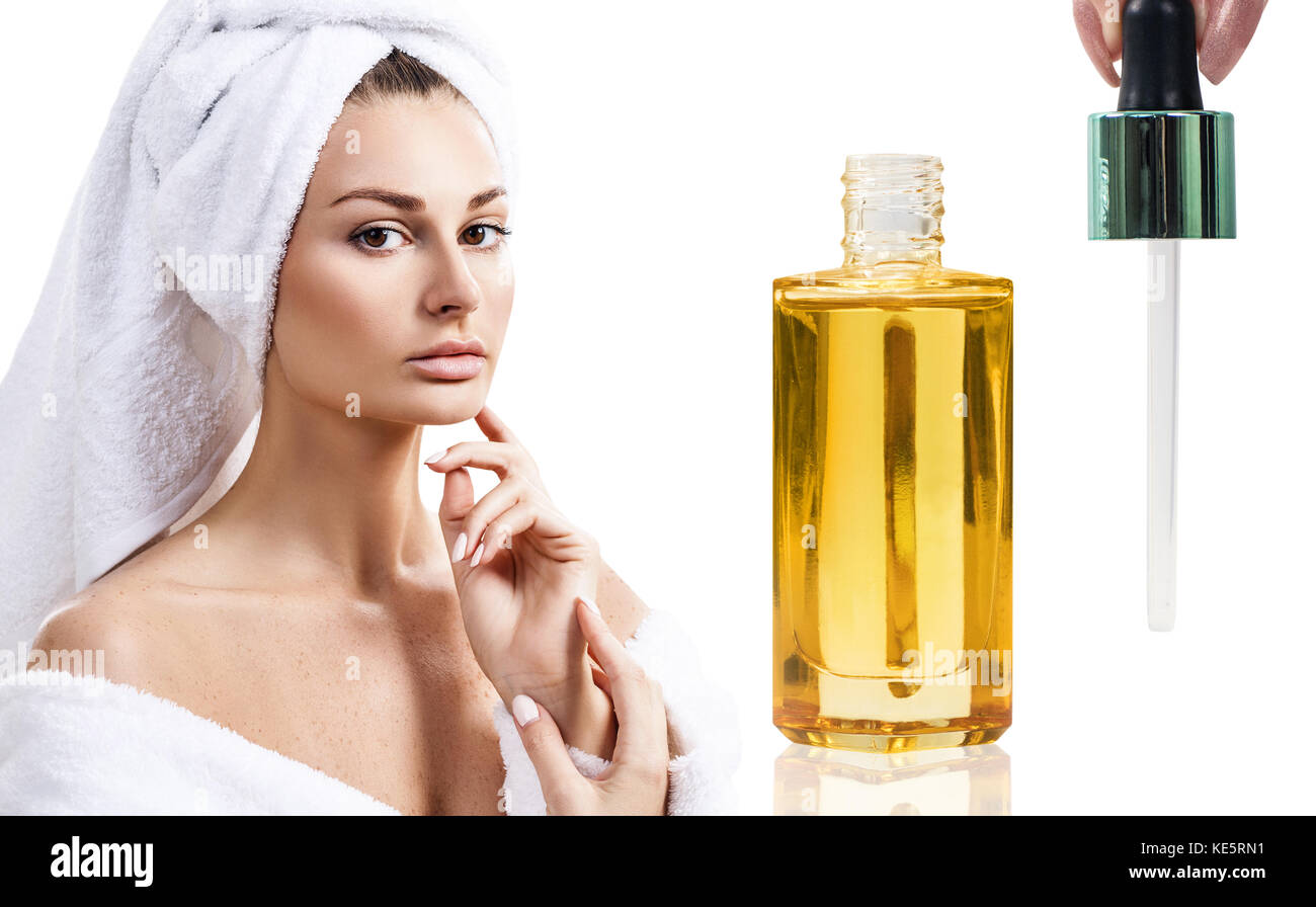 Cosmetic oil applying on face of young woman Stock Photo - Alamy