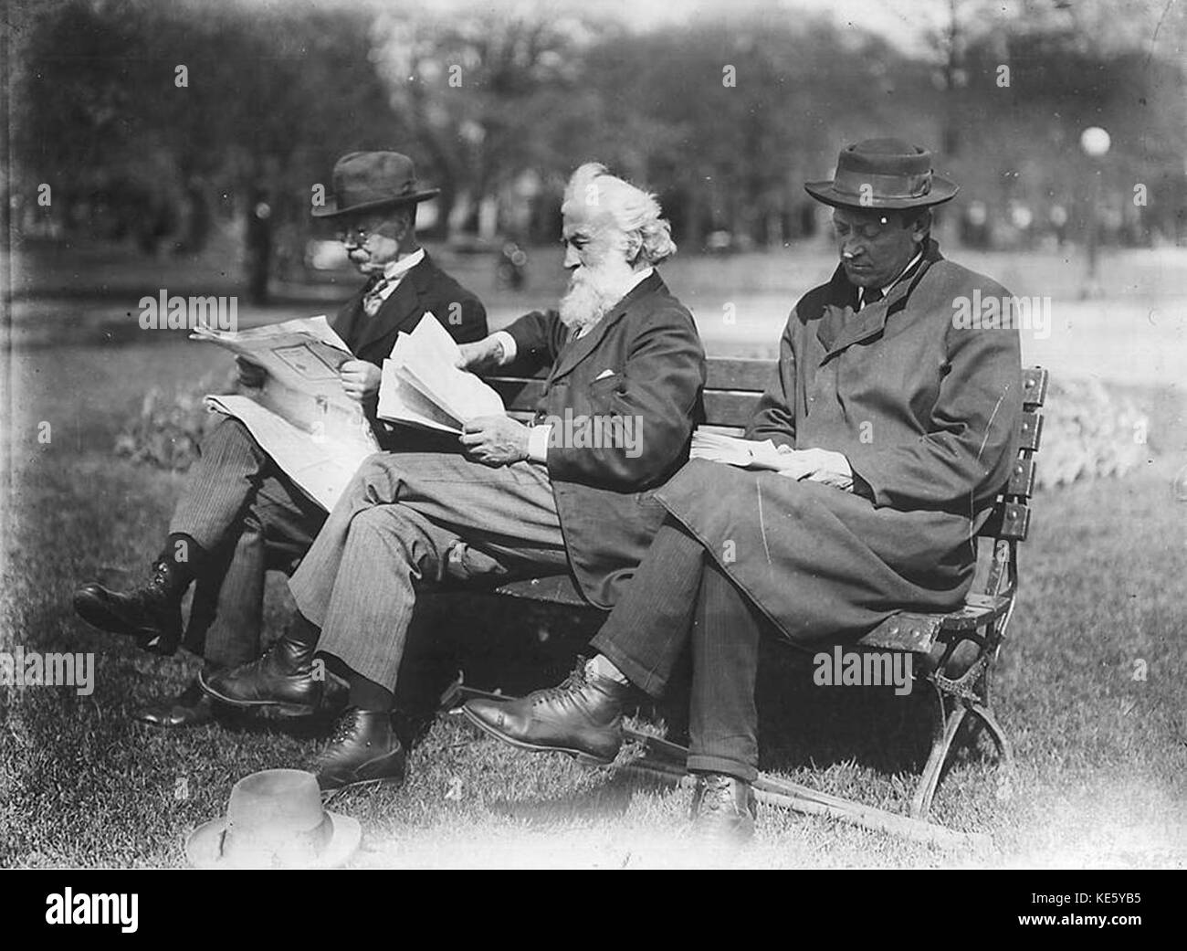 Three men on a bench Stock Photo - Alamy