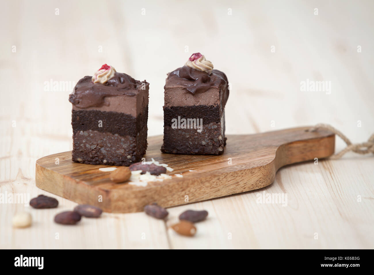 Two delicious raw vegan cakes on a wooden texture Stock Photo - Alamy