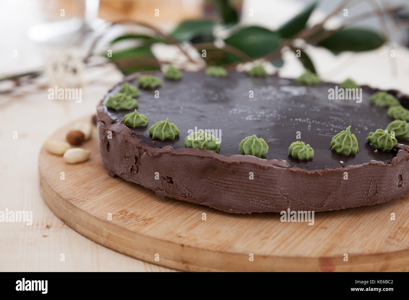A vintage view of a chocolate raw vegan cake, decorated with green ...