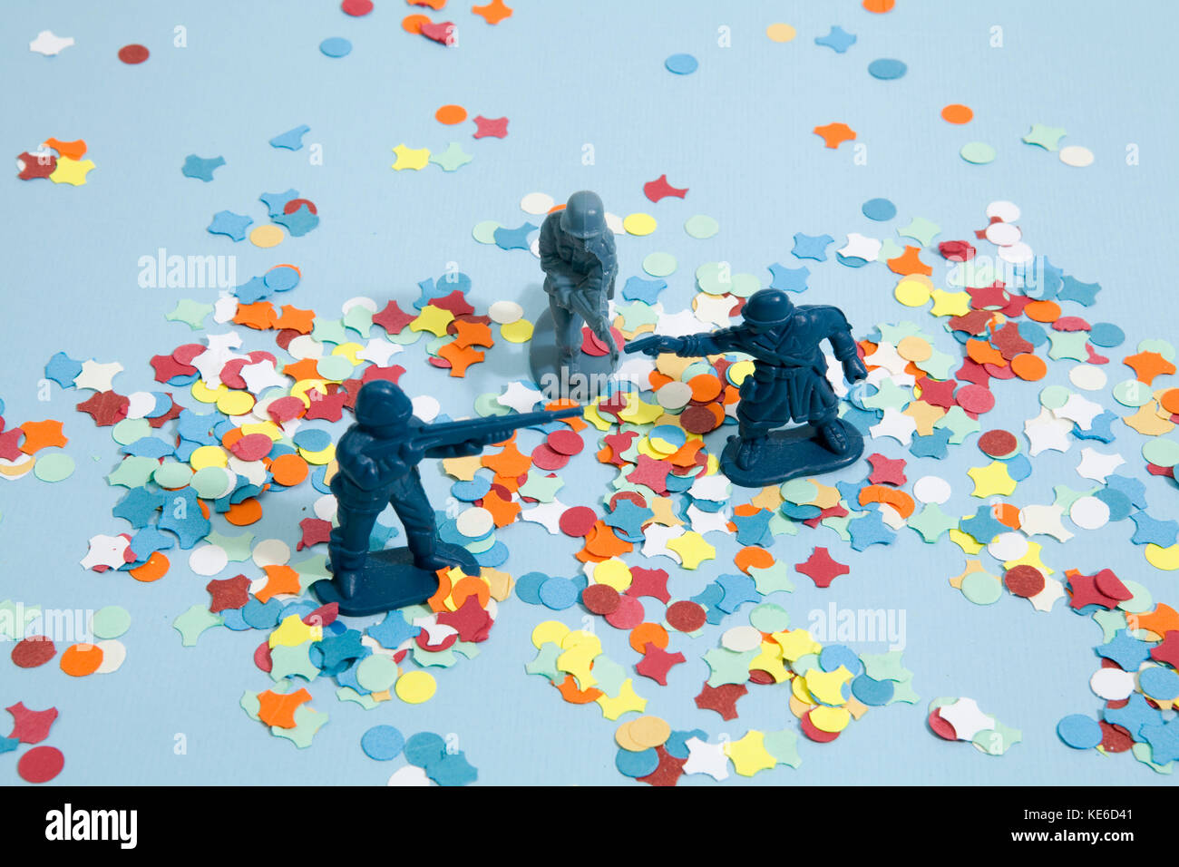 Battle between three plastic soldiers on a blue pop vibrant background ...