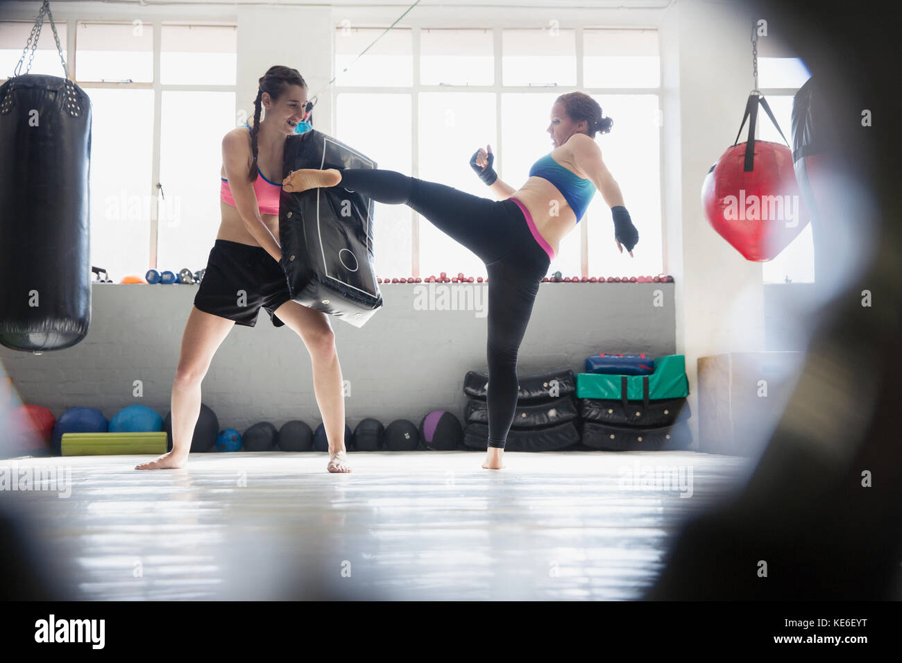 Women kickboxing with pad in gym Stock Photo - Alamy