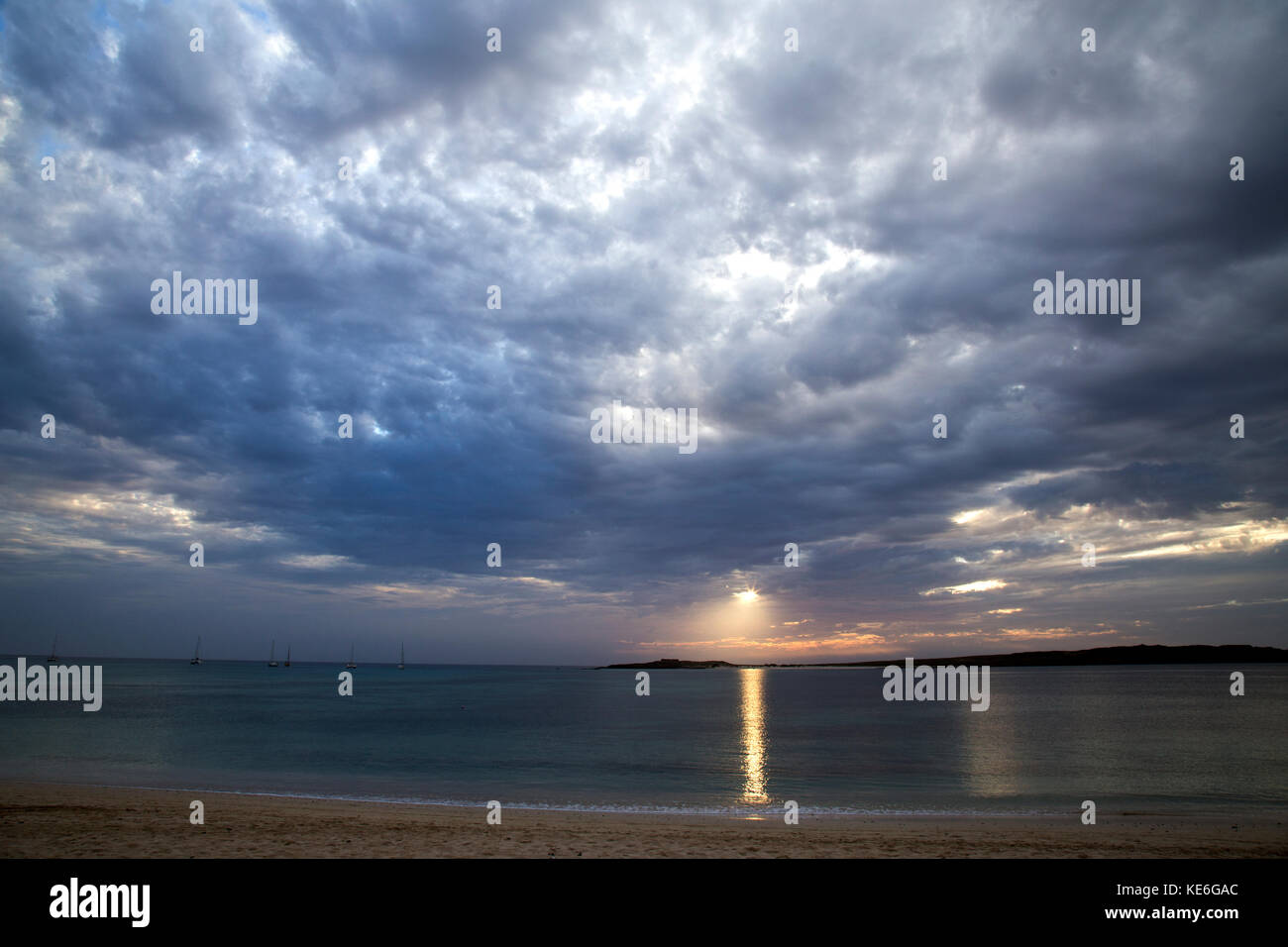 Sunset over the sea with dramatic cloudy sky Stock Photo - Alamy
