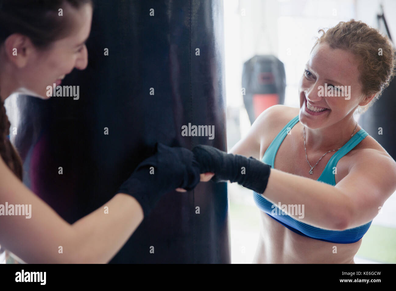 Smiling female boxers fist bumping in gym Stock Photo - Alamy