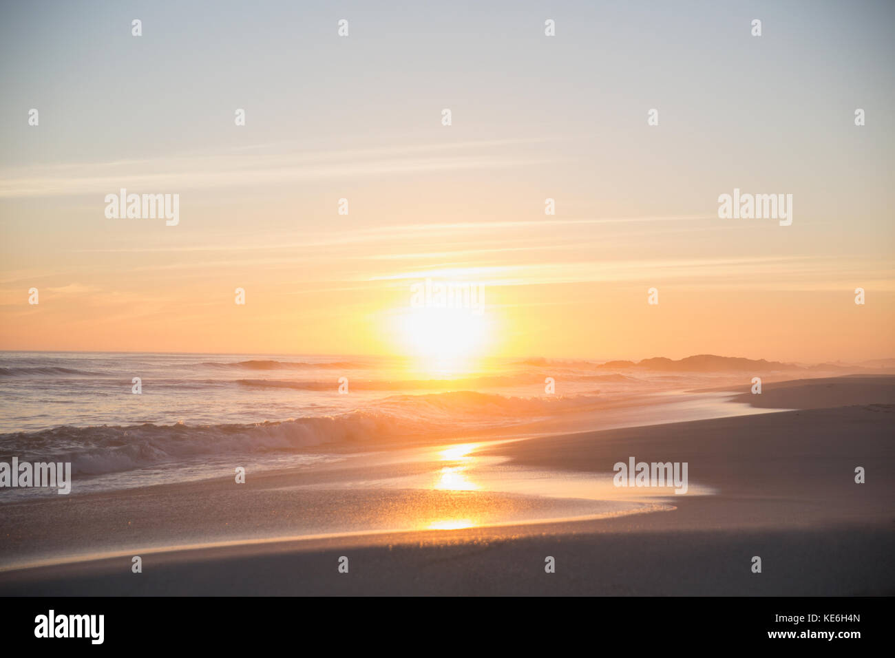 Tranquil sunset view over ocean beach Stock Photo - Alamy