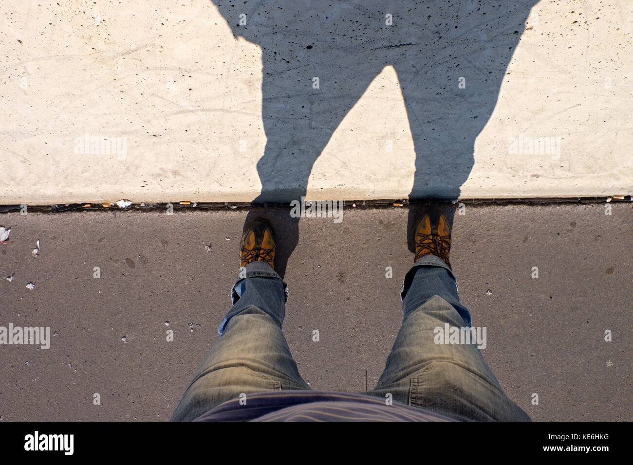 Man long legs stand on street at concrete wall with shadow Stock Photo ...