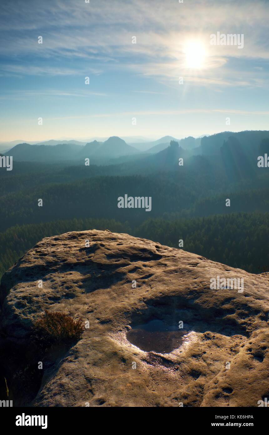 Spring misty morning in forest landscape. Majestic peaks cut lighting ...