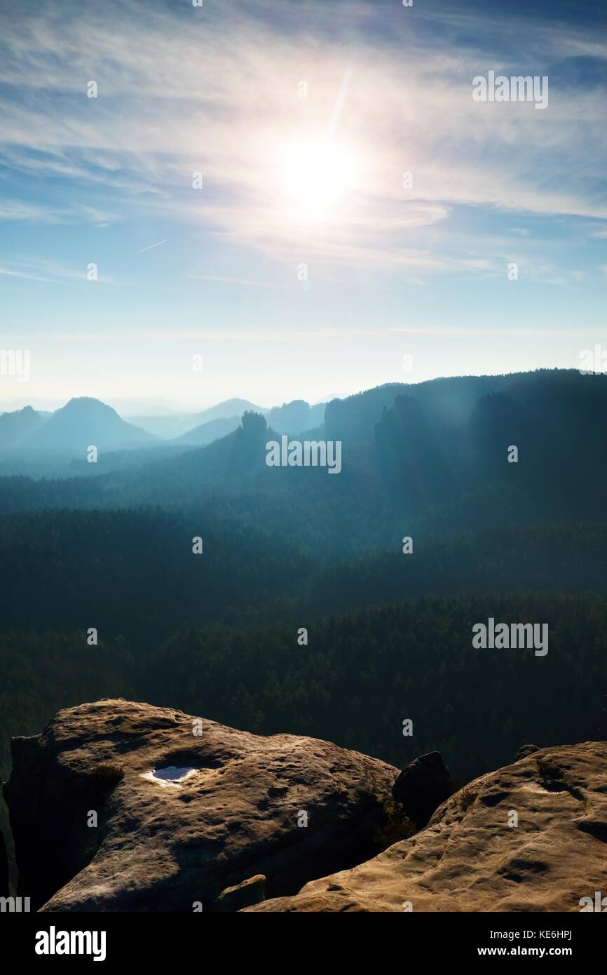Spring misty morning in forest landscape. Majestic peaks cut lighting ...