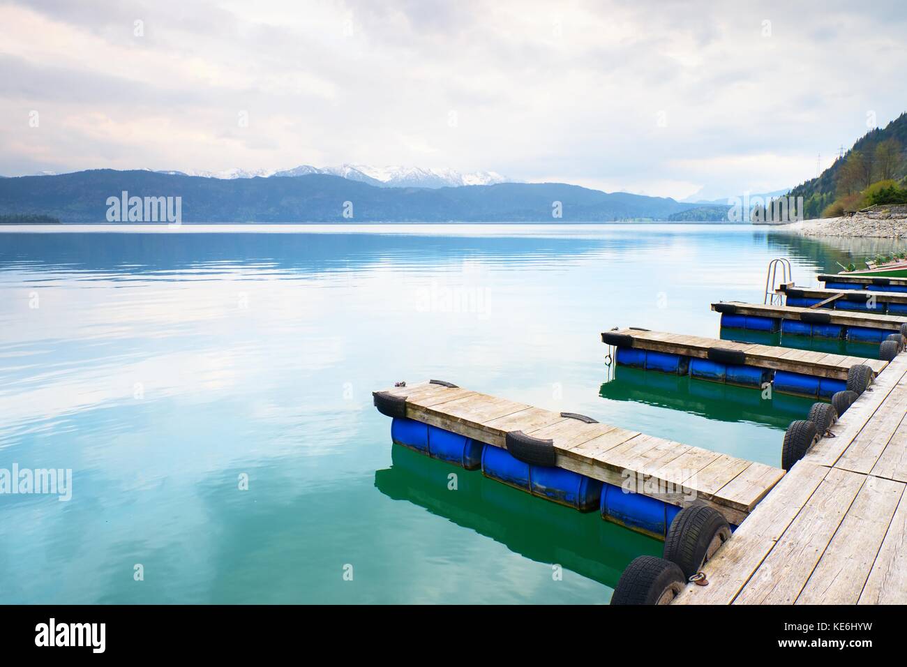 Blue Alps lake with Rental rowing boats in marina. Wharf for trip ships ...