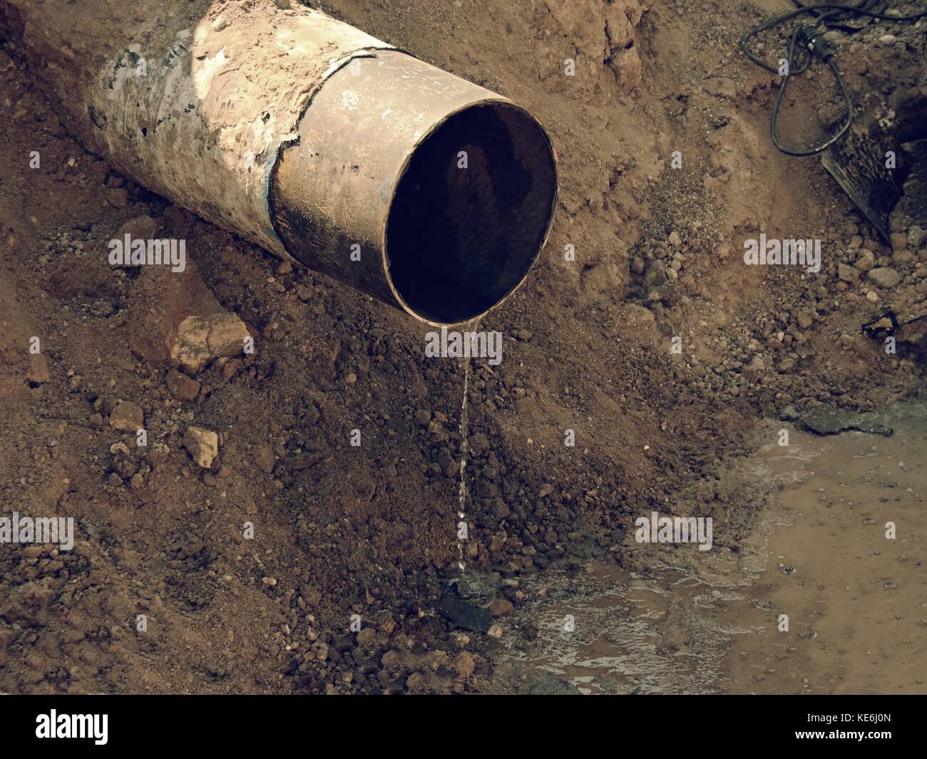 Rusty Old Iron Pipe With Clear Water Flowing From It. Waste water drain ...