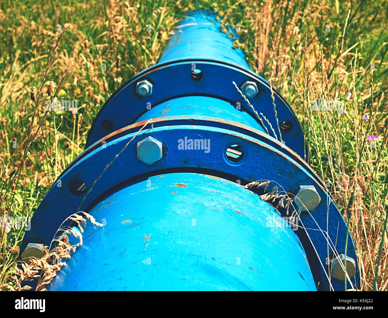 Repaired big drink water pipes joined with new blue flanges and silver ...