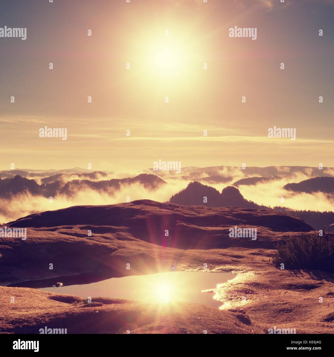 Hot sunny spring day between mountains summits. Sandstone cliff above ...