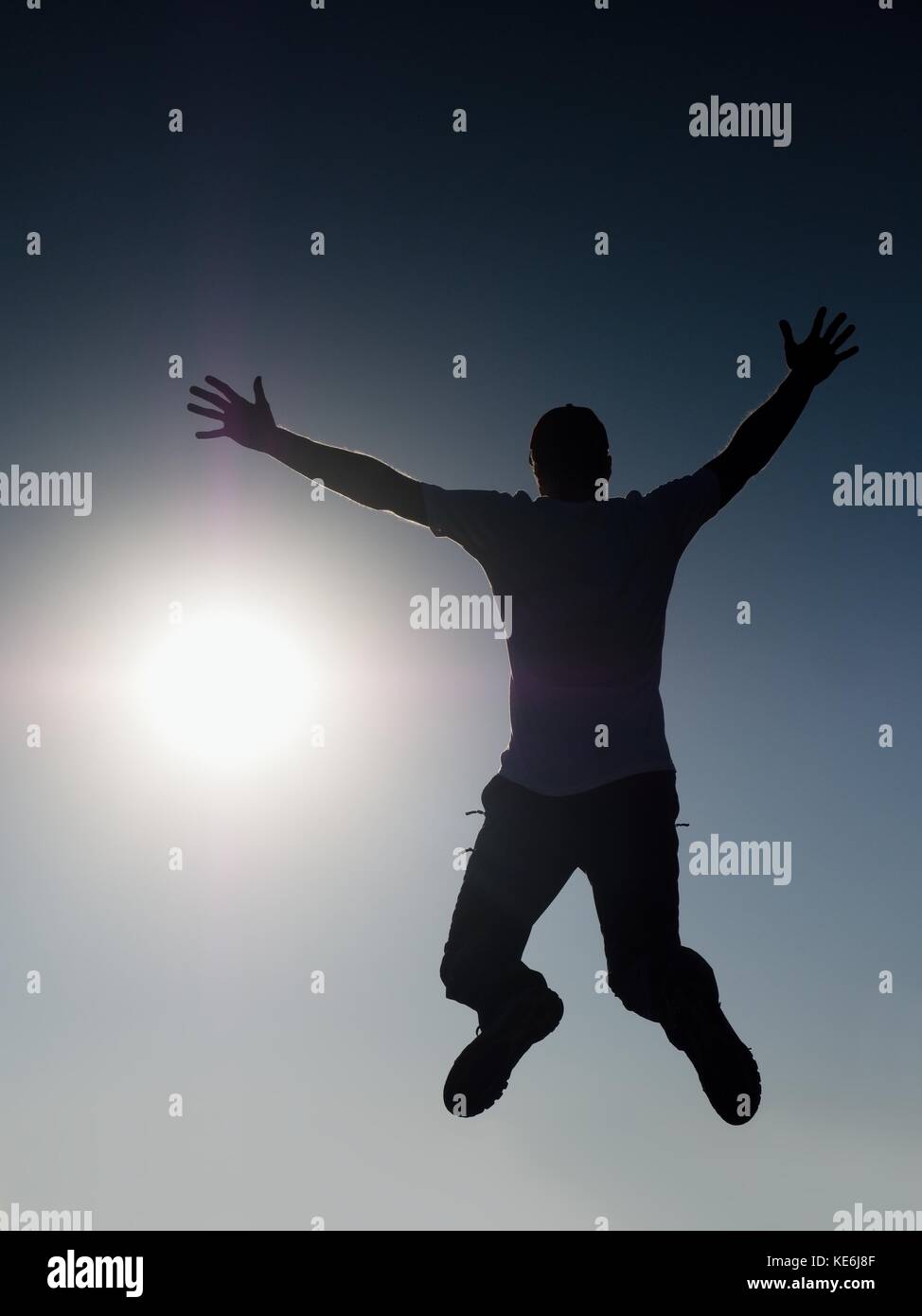 Man fly in air. Blue Toned effect. Man falling down with raised arms ...