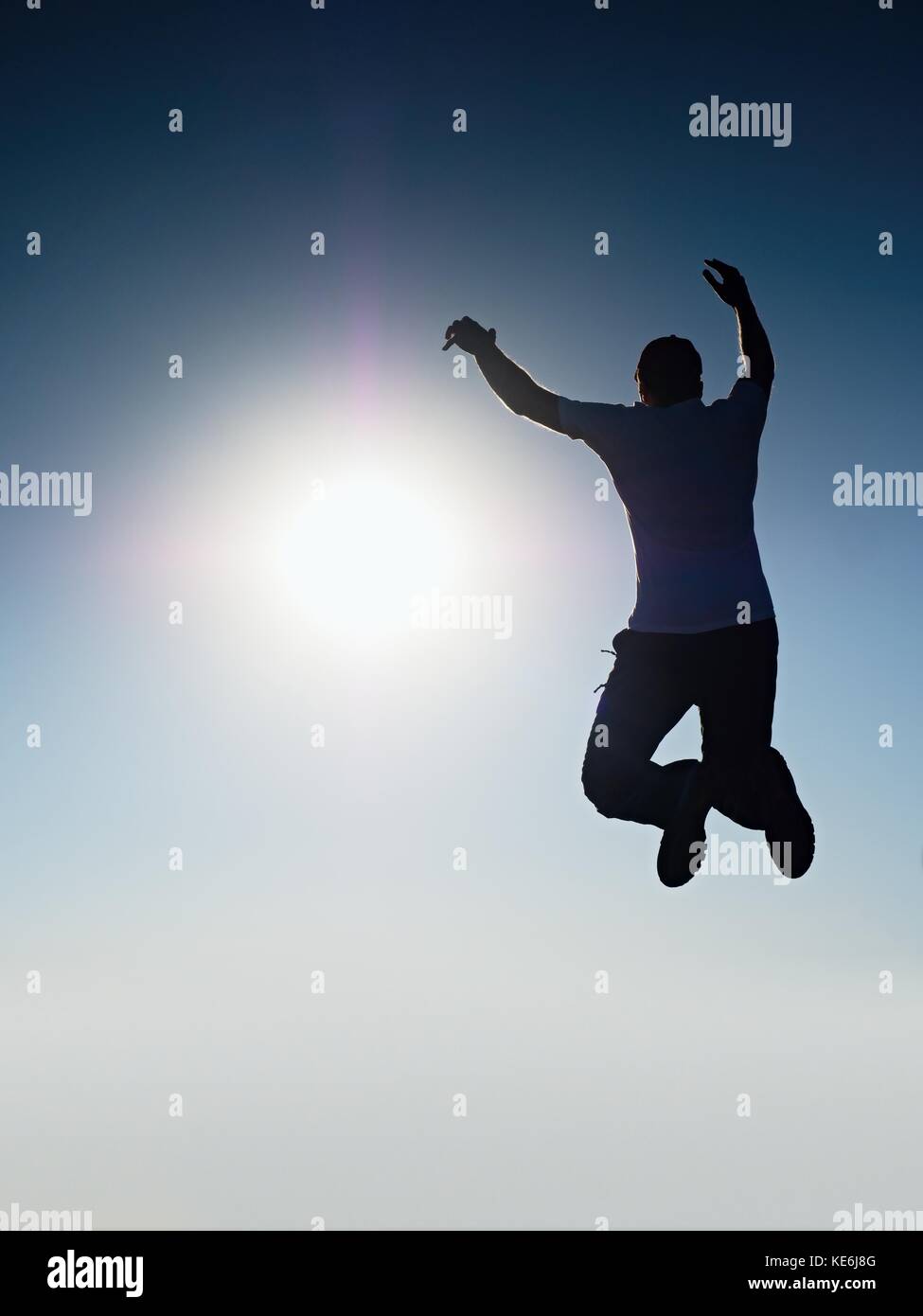 Man fly in air. Blue Toned effect. Man falling down with raised arms ...