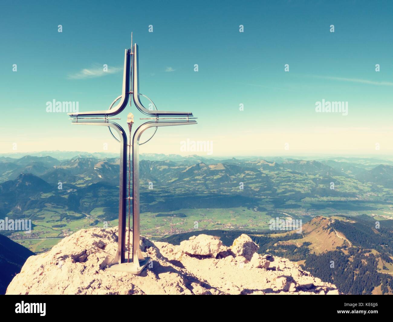 Praying summit cross on high rocky mountain. Steel artistic crucifix on ...