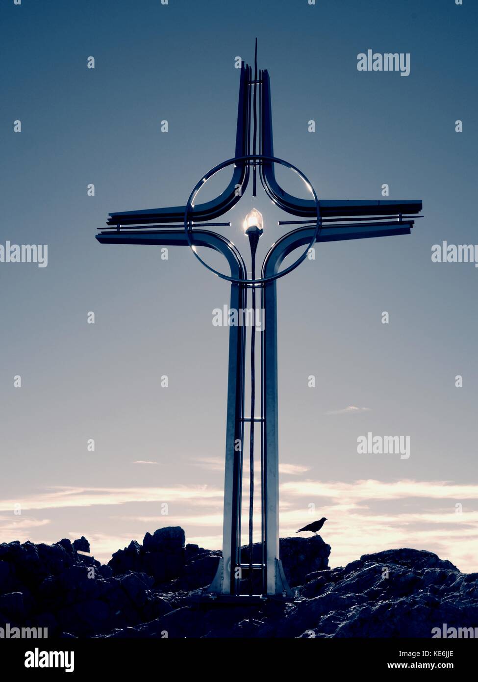 Praying summit cross on high rocky mountain. Steel artistic crucifix on ...