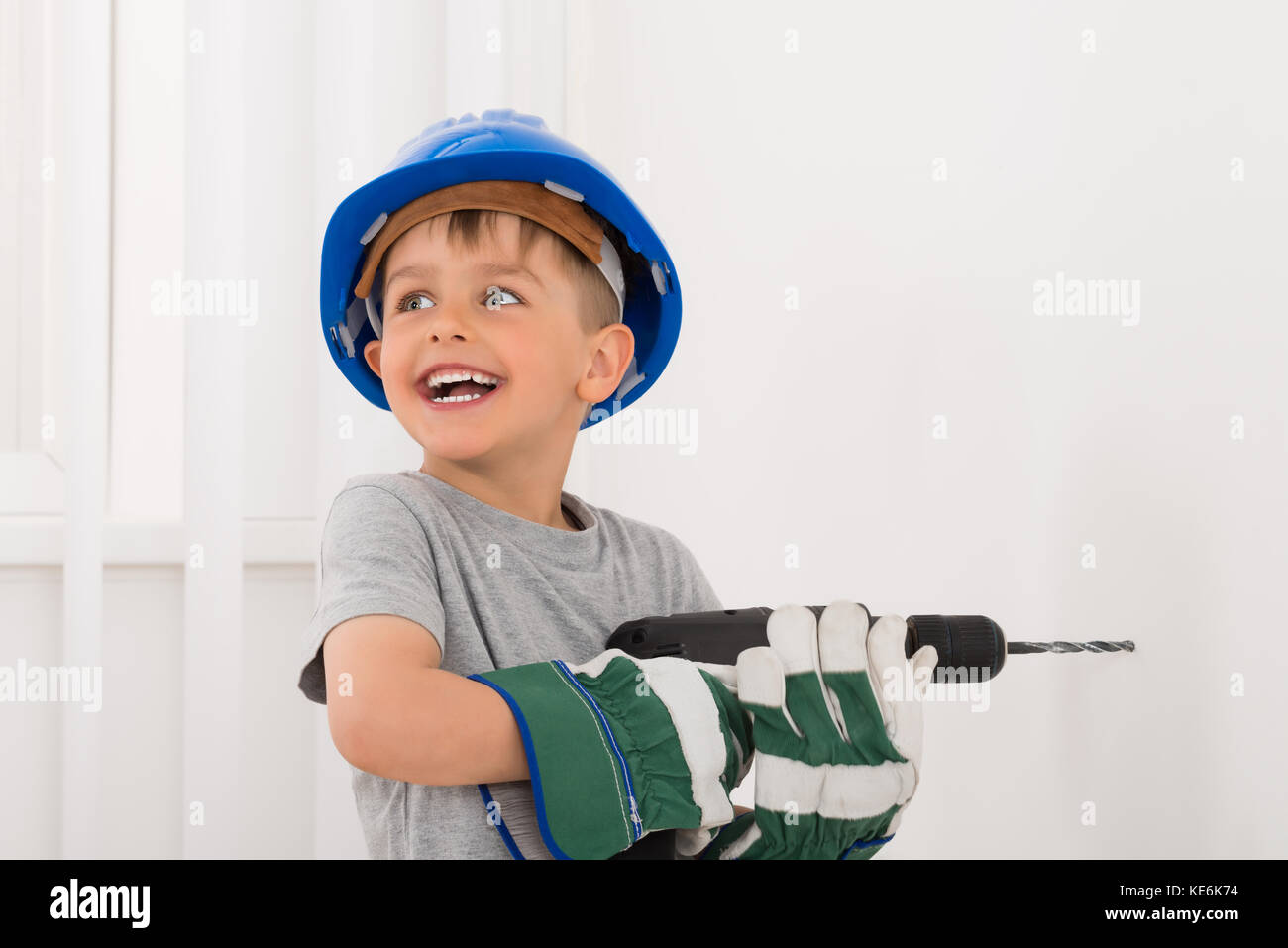 Little Boy Drilling Wall With Electric Drill At Home Stock Photo - Alamy