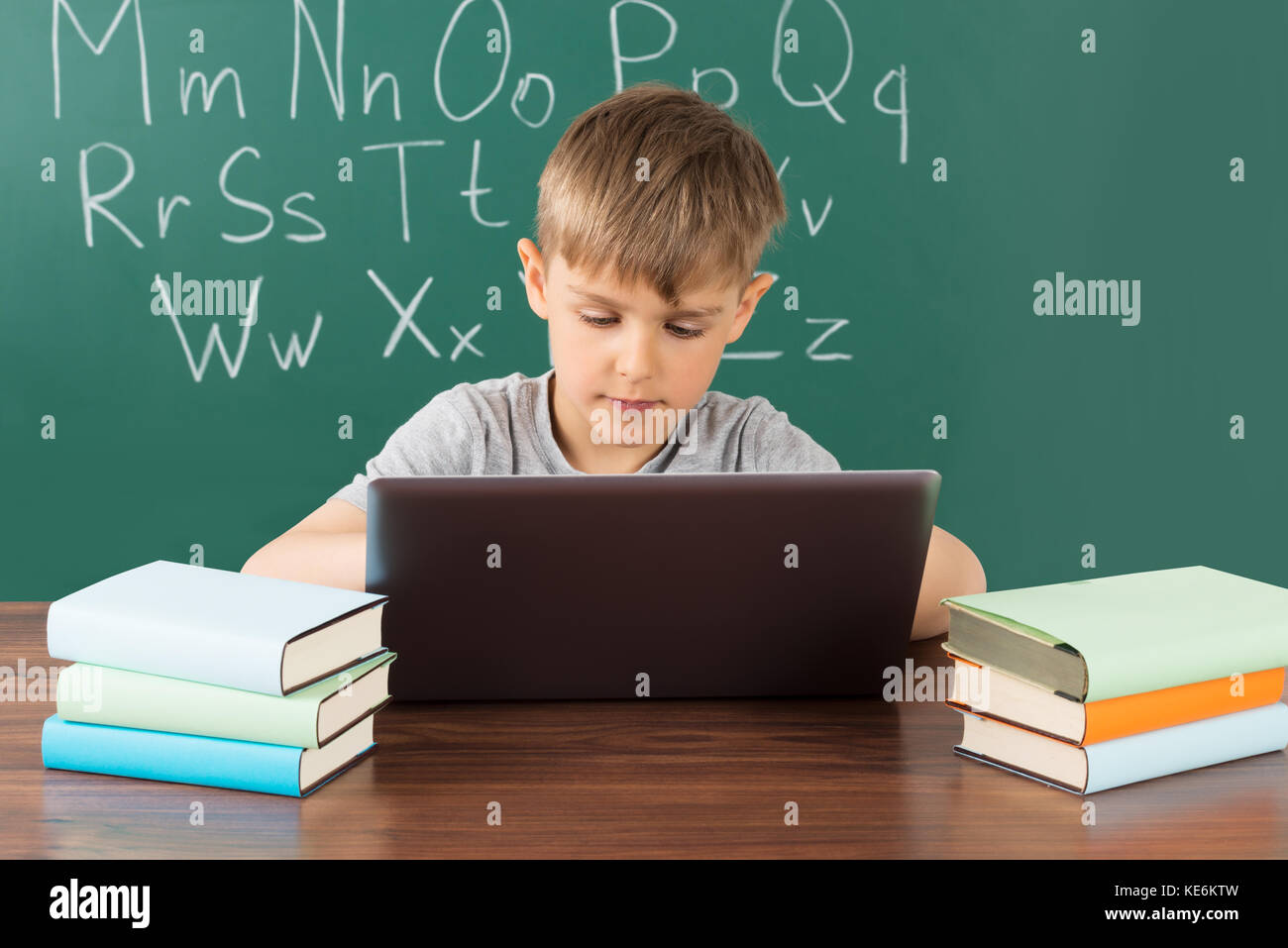 School boy desk laptop classroom hi-res stock photography and images ...