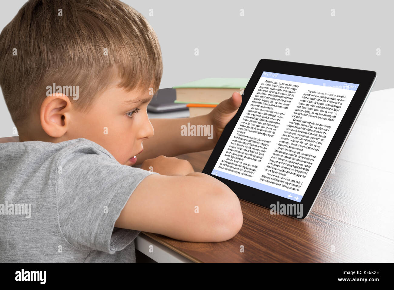 Close-up Of Cute Little Boy Learning Through Digital Tablet Stock Photo ...
