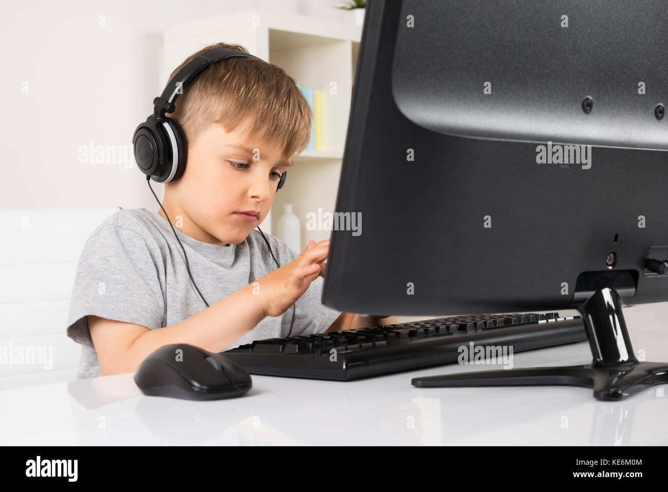 Boy listening music on computer hi-res stock photography and images - Alamy