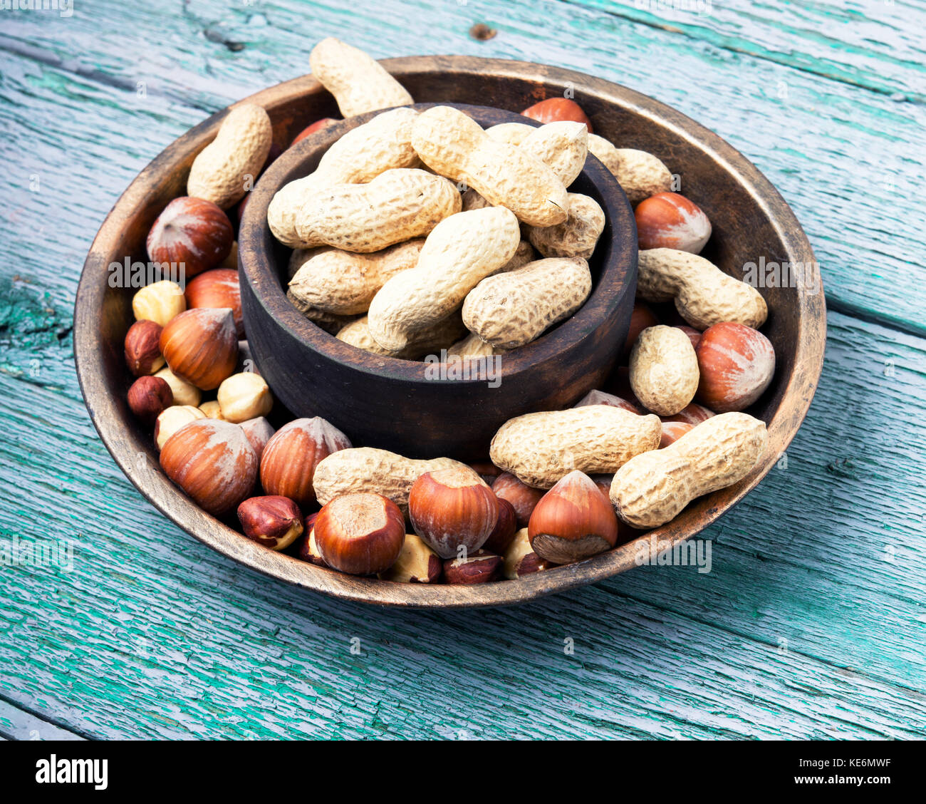 nut peanuts,hazelnuts in the shell and chipped in a bowl Stock Photo ...