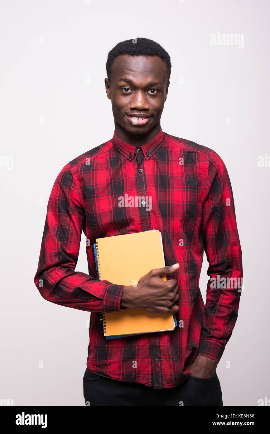 Young black student holding an electronic tablet isolated on a white ...