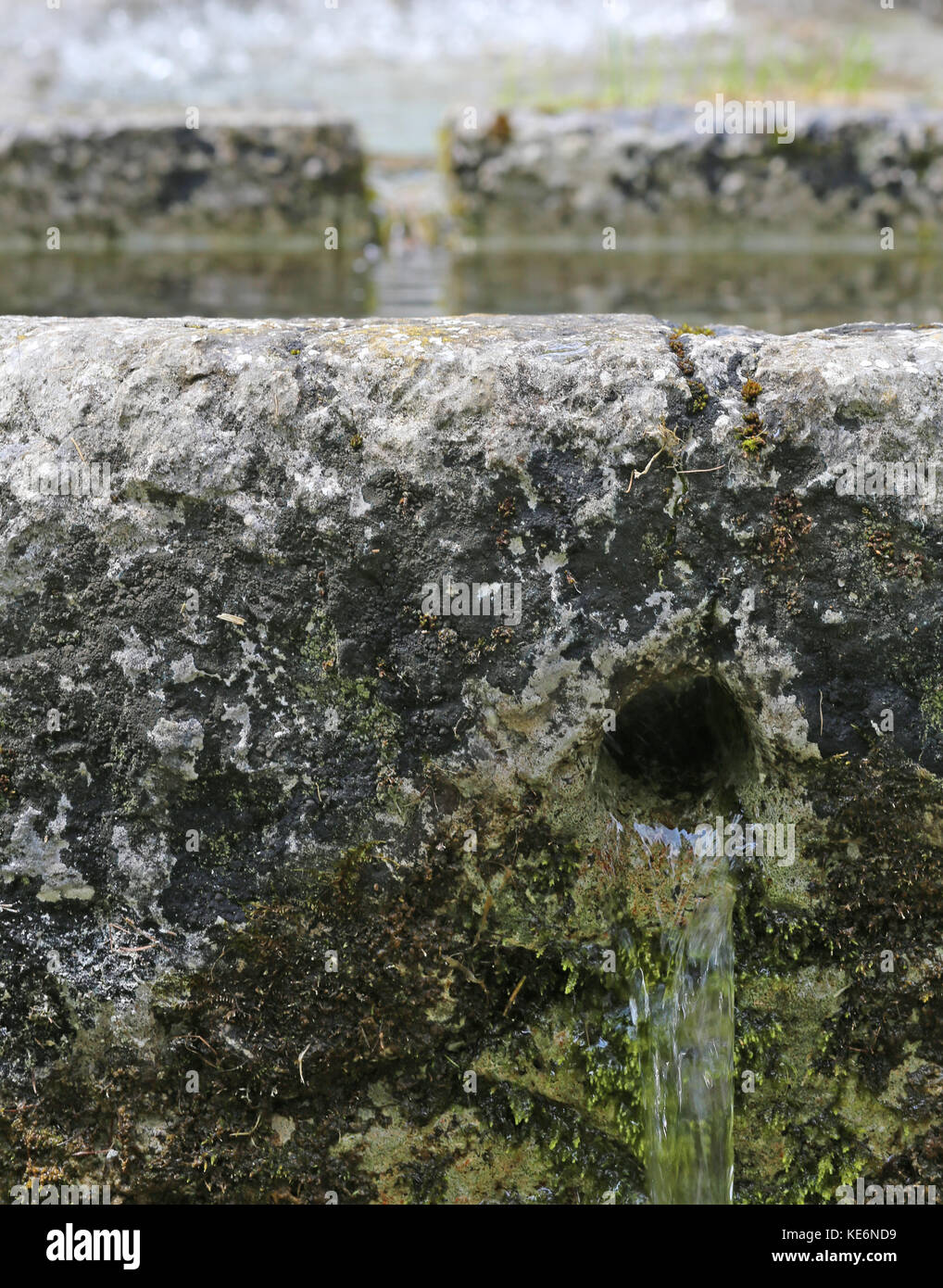 detail of ancient fountain made of stone and drinking water flowing ...