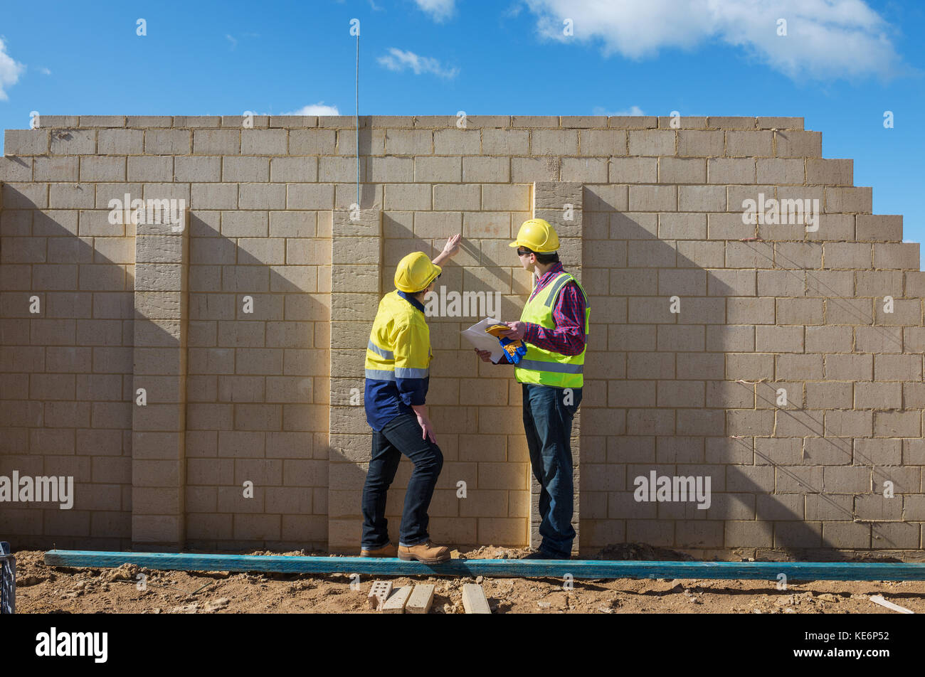 civil engineer and worker discussing issues at the construction site ...