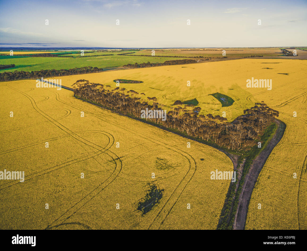 Aerial view of rural road passing through agricultural land in ...