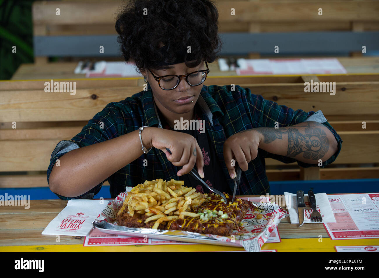 Jojo Fernanandes cuts into their giant chicken nugget dish which is ...