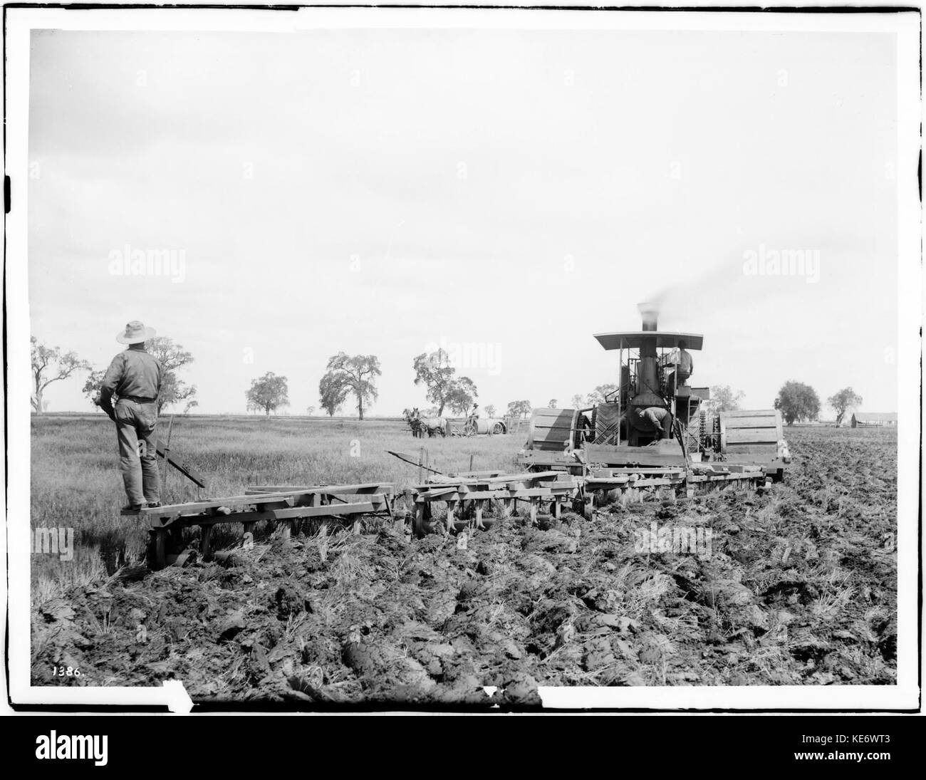 A historical photograph from around 1900 showing three men operating a ...